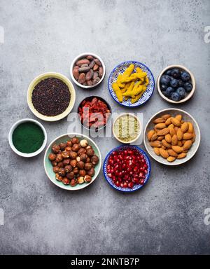 Close up detail of superfood pomegranate seeds in a white bowl on a ...