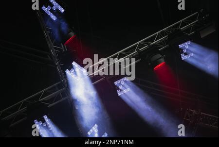 Concert lighting mounted on rack above the stage. High bar with ...