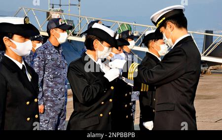 A female personnel of Japan's Maritime Self-Defense Force receives a ...