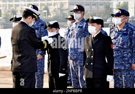 A female personnel of Japan's Maritime Self-Defense Force receives a ...