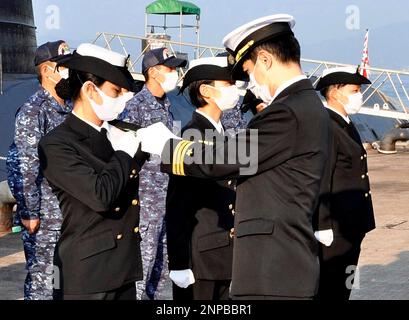A female personnel of Japan's Maritime Self-Defense Force receives a ...