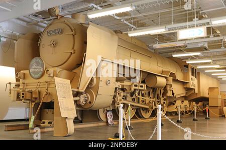 A photo shows a full-scale cardboard steam locomotive (SL) in Nankan ...