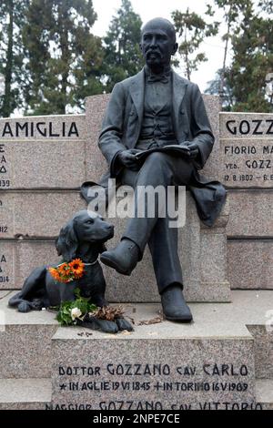 Grave of Guido Gustavo Gozzano a statue of a man sitting with a dog at ...