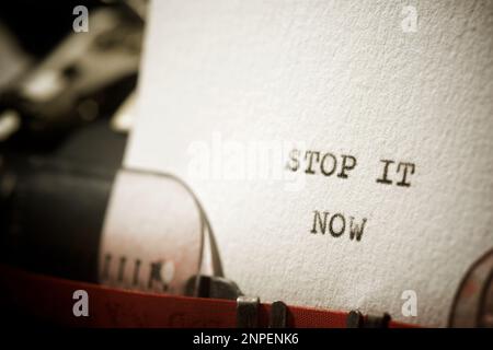 Stop it now text written with a typewriter Stock Photo - Alamy