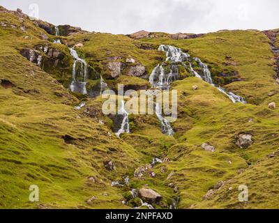 Dozens of small rivulets flowing down the rocks after a rainy day in ...