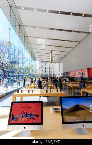 Interior of the Apple store in Omotesando, Tokyo. People looking at the ...