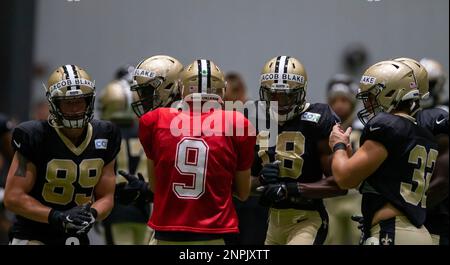 Wearing the name of Jacob Blake on their helmets the offense breaks huddle with New Orleans Saints quarterback Drew Brees 9 during an NFL football training camp practice in Metairie La. Thursday