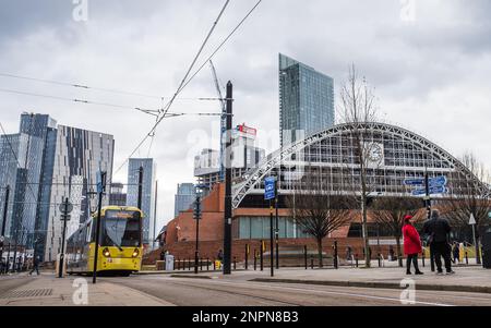 A yellow Metrolink tram passes the Manchester Central Convention ...