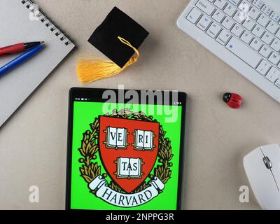The Harvard University logo is displayed on a metal gate leading to ...