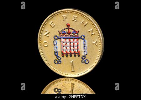 A uk colourised one penny coin featuring a crowned portcullis with ...