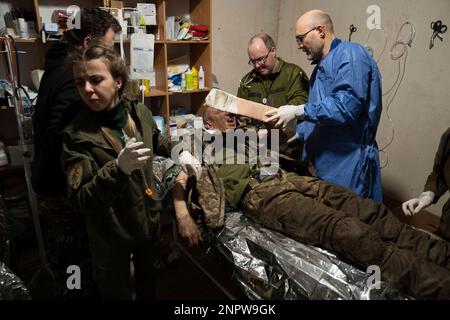 Ukrainian military medics treat their wounded comrade at the field ...