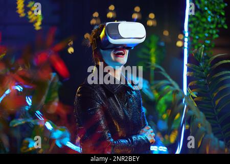 stylish female in metaverse in vr headset pressing the button in the ...