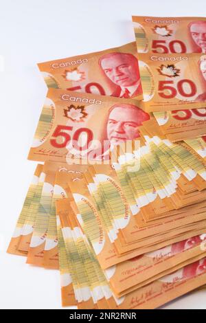Canadian money spread on a white background Stock Photo - Alamy