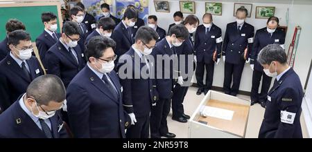 Station staffs offer flowers for victims who were killed in the sarin ...