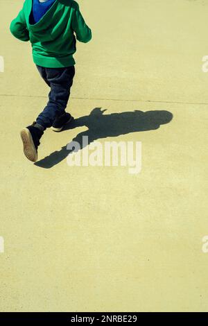 Boy running away on the street Stock Photo - Alamy