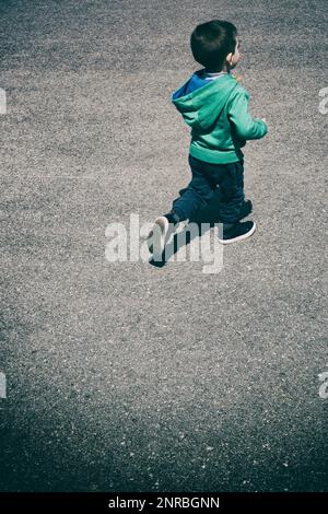 Boy running away on the street Stock Photo - Alamy