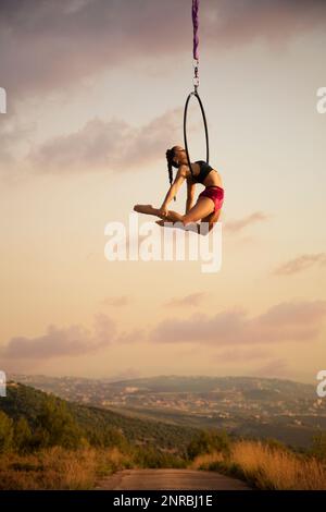 Female aerialist performing on a hoop Stock Photo - Alamy