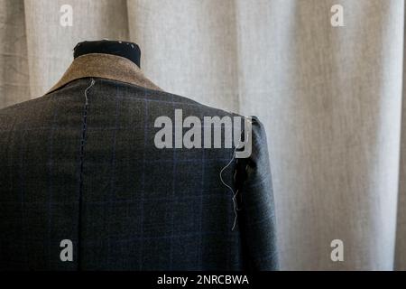 Details of a tailored suit jacket with markings on it for stitching ...