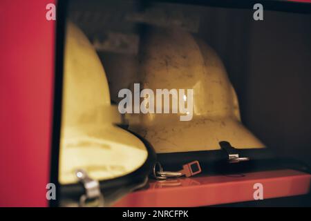 Firefighter coat hanging on fire truck Stock Photo - Alamy