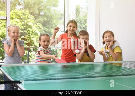 Cute happy children playing ping pong indoors Stock Photo - Alamy