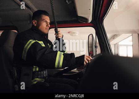 Firefighter using radio set while driving fire truck, closeup Stock ...