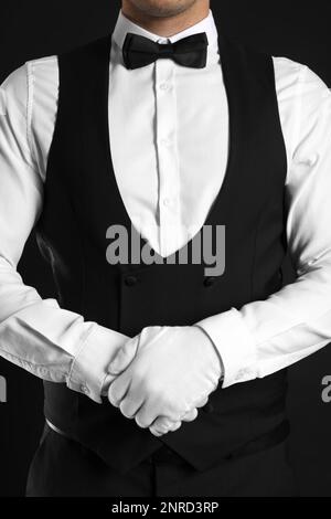 Butler in elegant uniform on black background, closeup Stock Photo - Alamy