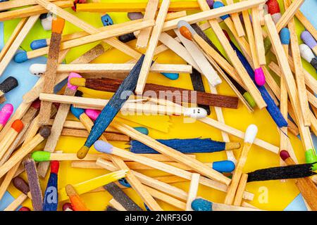 matchsticks of various shapes and colors with multicolored paper sticky ...
