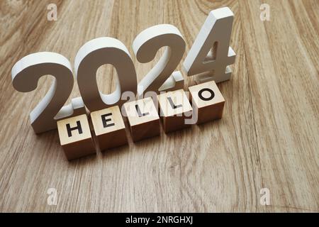 Hello 2024 alphabet letters decorate with flowers on wooden background Stock Photo - Alamy