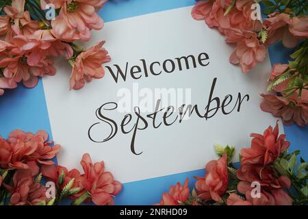 Welcome September text with Pink Flower frame on blue background Stock ...