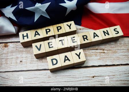 Happy Veterans Day alphabet letter and American flag on wooden ...