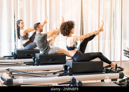Group of sportive people training in a gym - Multi-ethnic group of ...