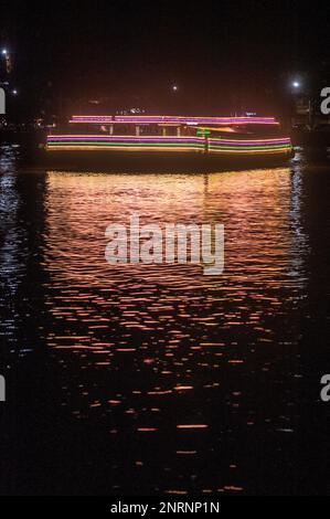 Dinner cruise boats on the Praek Tuek Chhu River at night. Bilingual ...