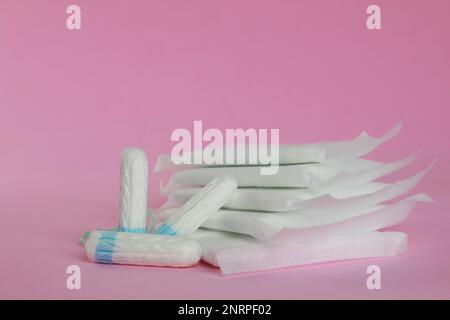 Menstrual tampons and pads on a pink background. Menstruation cycle ...