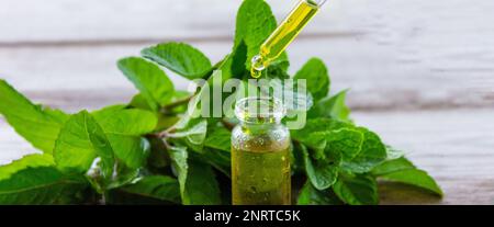 The mint extract in a small jar. Selective focus Stock Photo - Alamy