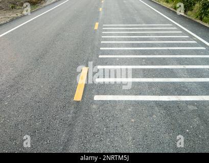 White transverse rumble strips on the asphalt road for causing a loud ...