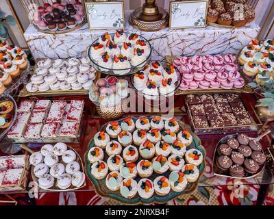 Candy bar with different assortments of cakes Stock Photo - Alamy