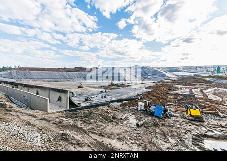 A concrete box culvert with a geomembrane covering and stabilizing ...