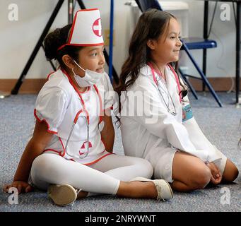 Alice Byrne Elementary School students pause during their recess to ...