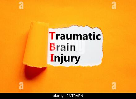 TBI traumatic brain injury symbol. Concept words TBI traumatic brain injury on wooden stick on a ...