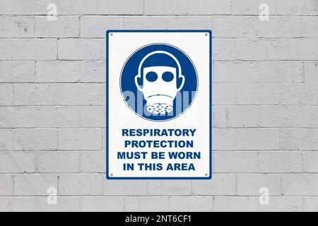 Warning sign screwed to a cinder block wall to warn about a health ...