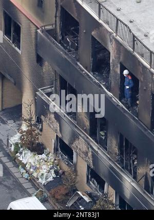 An aerial photo shows officials conduct an investigation at the arson ...