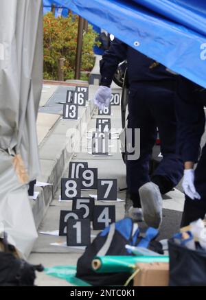 OSAKA, Japan - Police officers investigate a crime scene in Neyagawa ...