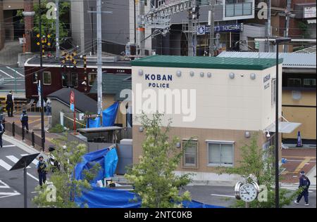 OSAKA, Japan - Police officers investigate a crime scene in Neyagawa ...