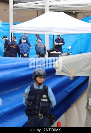 OSAKA, Japan - Police officers investigate a crime scene in Neyagawa ...