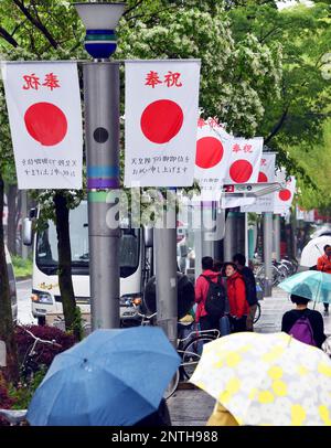 The national flags of Japan are set up to celebrate Emperor's ...