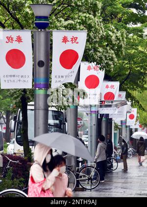 The national flags of Japan are set up to celebrate Emperor's ...