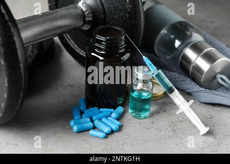 Different drugs and sports equipment on grey background. Doping control ...