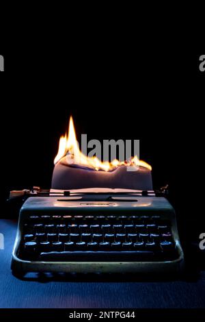typewriter and sheet of paper catching fire Stock Photo - Alamy