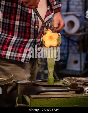 A glassworks worker shows traditional methods of making decorative ...