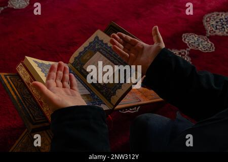 Islamic photo. Muslim man praying with Holy Quran on background ...